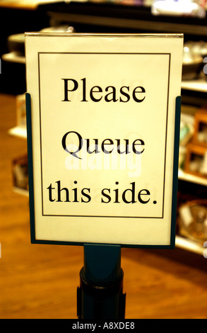 Please queue here Stock Photo - Alamy