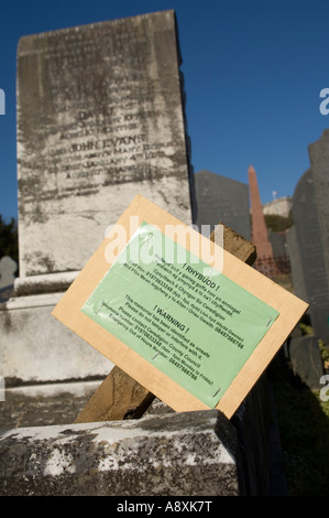 Unsafe warning notice on gravestone Stock Photo - Alamy
