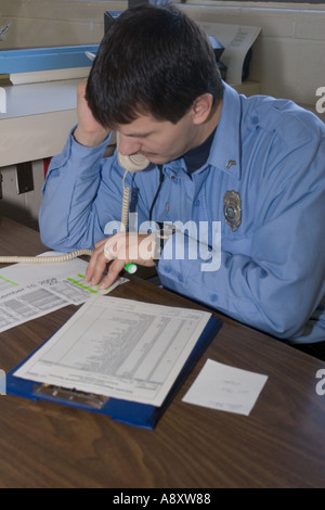 Corrections officer doing paperwork at desk Nebraska State Penitentiary ...
