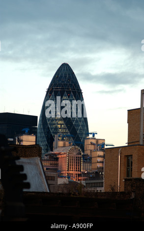 Reflection of The gerkin Gherkin 30 St. Mark Axe in puddle on a rainy ...