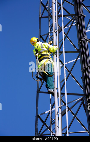 Rigger working on mobile phone antennas on steel lattice tower Stock ...
