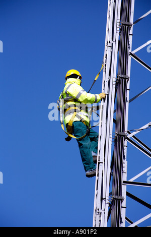 Rigger working on mobile phone antennas on steel lattice tower Stock ...