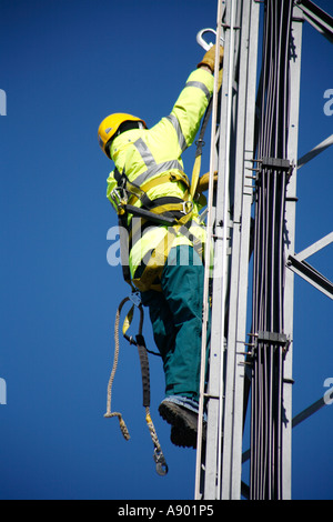 Rigger working on mobile phone antennas on steel lattice tower Stock ...