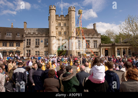 Children dance round the ancient maypole on the village green of Wellow ...