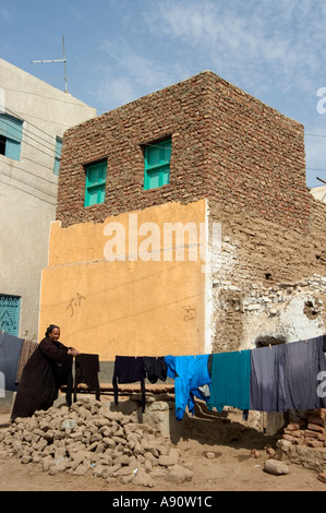woman hanging drying washing Elephantine Island Aswan Upper Egypt Egypt ...