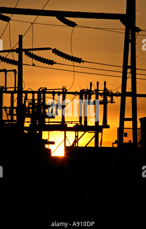 Sun setting behind power transformers Stock Photo - Alamy