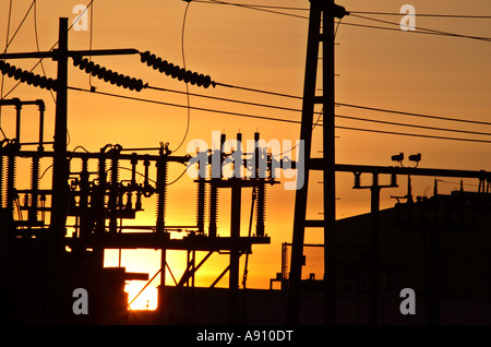 Sun setting behind power transformers Stock Photo - Alamy