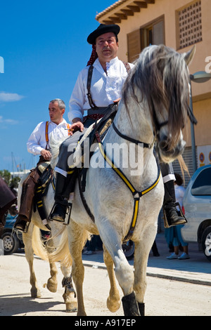 Elegant horseman in traditional spanish costume riding at a local ...