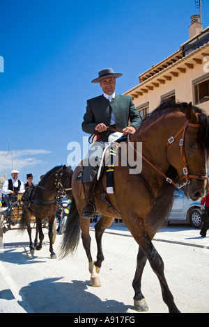 Elegant horseman in traditional spanish costume riding at a local ...