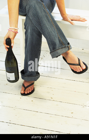 Young womans legs and feet with Champagne Bottle Stock Photo - Alamy