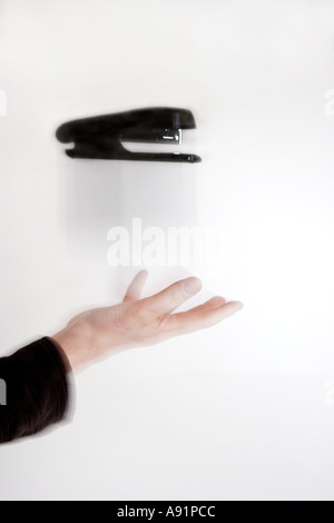 A hand about to grab a flying stapler Stock Photo - Alamy