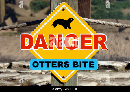 Danger otters bite sign Stock Photo - Alamy