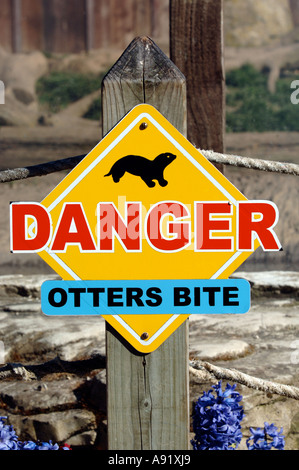 Danger otters bite sign Stock Photo - Alamy