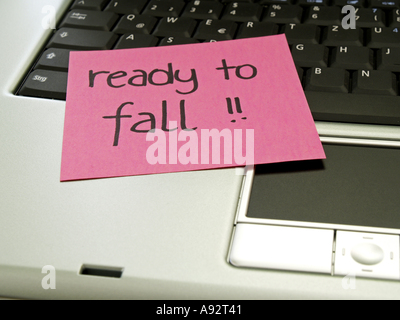 Memo note on notebook, ready to fall Stock Photo - Alamy