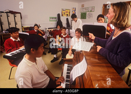 High school band music teacher and student playing flute Stock Photo ...