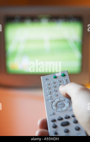 man changing tv channel with remote control while eating sandwich Stock ...
