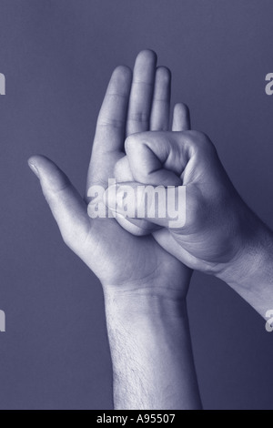 Hand hitting fist into palm to make a point Stock Photo - Alamy