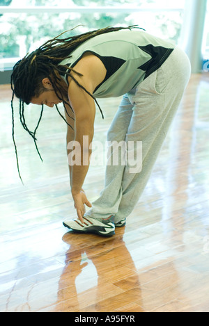Man doing standing forward bend, full length Stock Photo - Alamy
