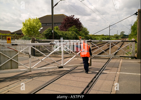 Railway crossing with a opening barrier or gates and signalling in the ...