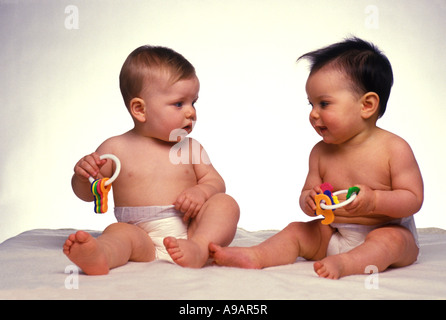 INFANT BABIES PLAYING WITH COLORED PLASTIC TOY KEYS Stock Photo - Alamy