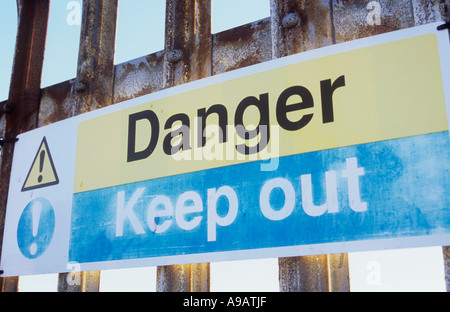 a keep out sign fixed to the security fence around a construction site ...