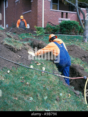 WORKERS INSTALLING NATURAL GAS LINE INTO RESIDENTIAL HOME Stock Photo ...