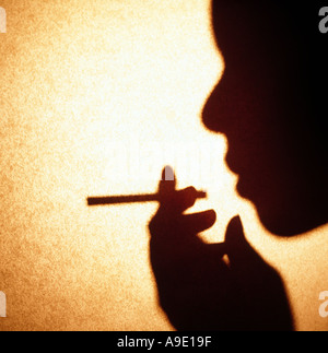 Hand is holding a cigarette on black background Stock Photo - Alamy