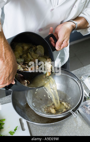 chef straining stock Stock Photo - Alamy