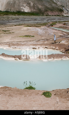 Hot springs thermal baths with turquoise water under fall foliage trees ...