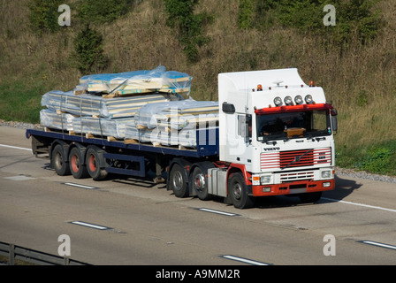 M25 motorway flat back lorry travelling empty Stock Photo - Alamy