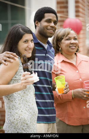 Multiracial couple and young son smiling and hugging outdoors Stock ...