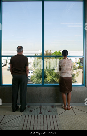 Two workers looking out of the window at the Kolukkumalai Tea Factory ...