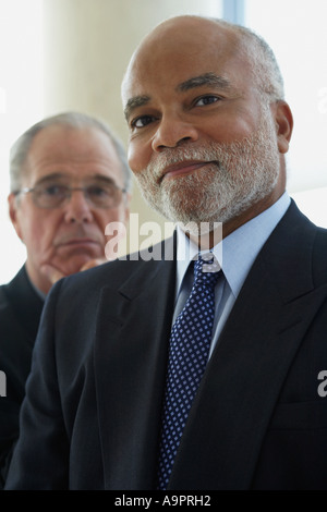 Serious African businessman leading his team Stock Photo - Alamy