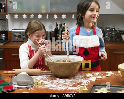 Boy mixing dough for Christmas cookies helping his mother Stock Photo ...
