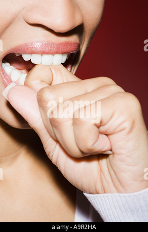 woman biting her knuckle Stock Photo - Alamy