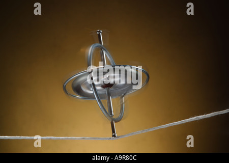 Spinning gyroscope on a string Stock Photo - Alamy