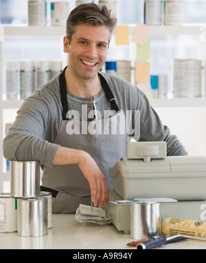 Portrait of store clerk standing at counter in supermarket Stock Photo ...