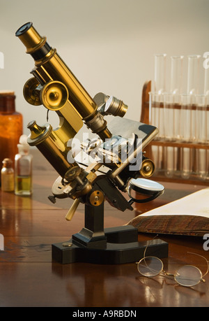 Old fashioned microscope on table Stock Photo - Alamy