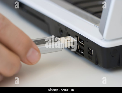 Plugging a USB device into a laptop computer Stock Photo - Alamy