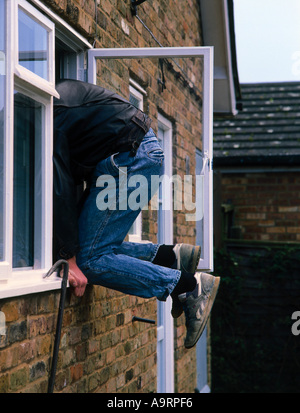 Burglar climbing into an open window Stock Photo - Alamy