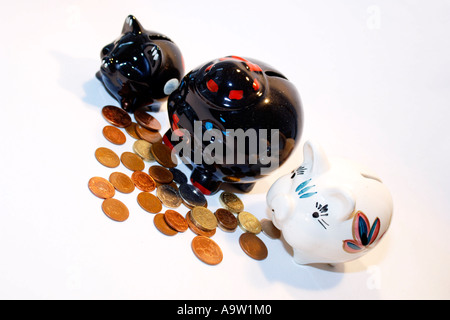 Three spotted Piggy Bank pigs surrounded by coins Stock Photo - Alamy