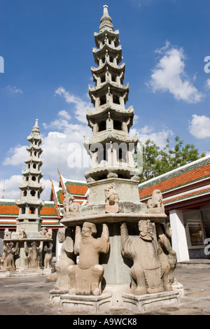 Vertical shot of a stone pagoda tower near beautiful cherry blossom and ...