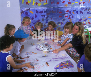 Kids around table in kindergarten class from above Stock Photo - Alamy