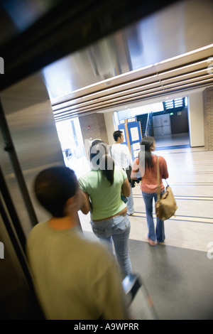 Young diverse students leaving university after lesson - Youth and ...