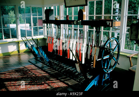 An old railway signal box with levers, clocks and signalman at ...