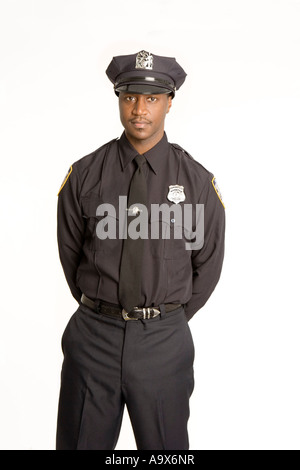 Portrait of an Afro American police officer holding a hand up to motion ...