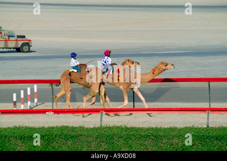 Children camel jockeys at a camel racing, Dubai, UAE 1990s Stock Photo ...