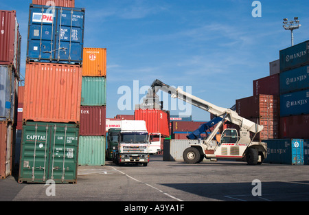 container truck in the container stacks loading container onto flatbed ...