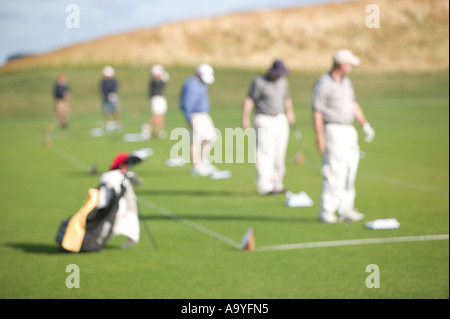Golfers on a practice range Stock Photo - Alamy