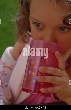 Little girl with beaker of water Stock Photo - Alamy